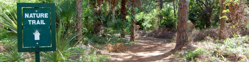 Sign for nature trail beside a dirt path through a forest. - #SoooBoca ...